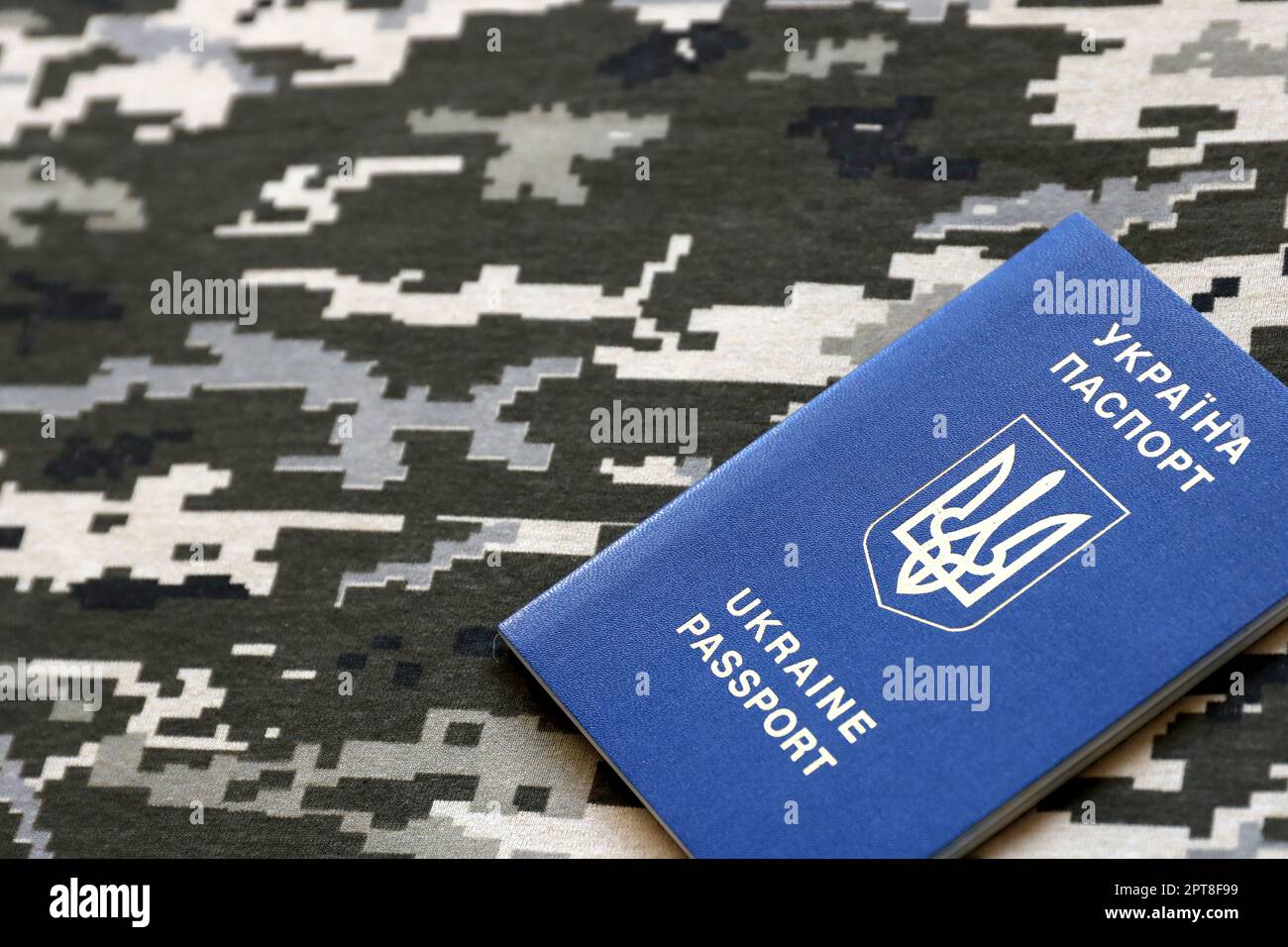 Ukrainian foreign passport on fabric with texture of military pixeled ...