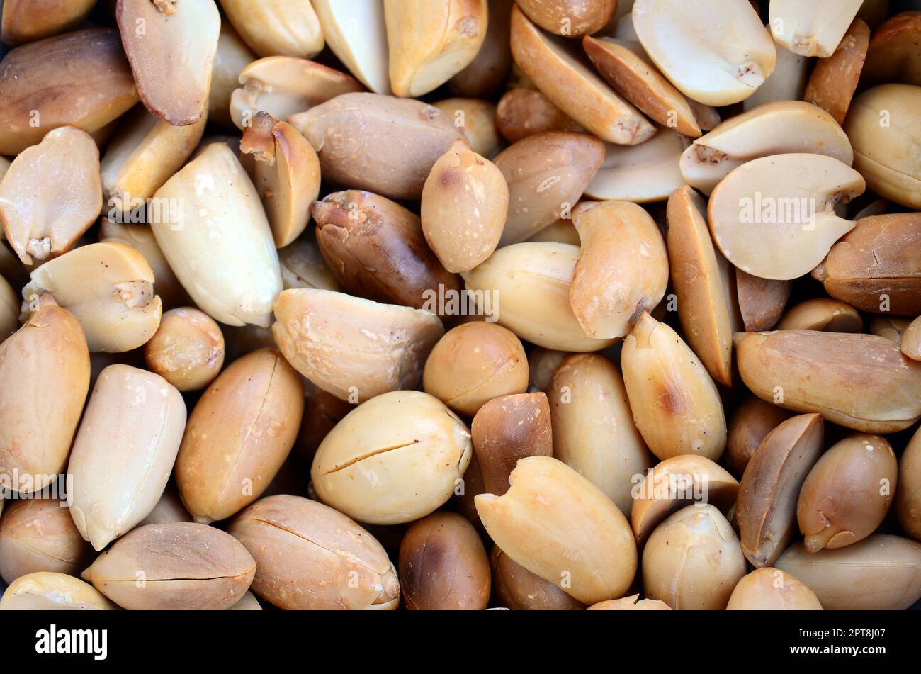 Peanut. A lot of small yellow nuts without peel. Background texture ...