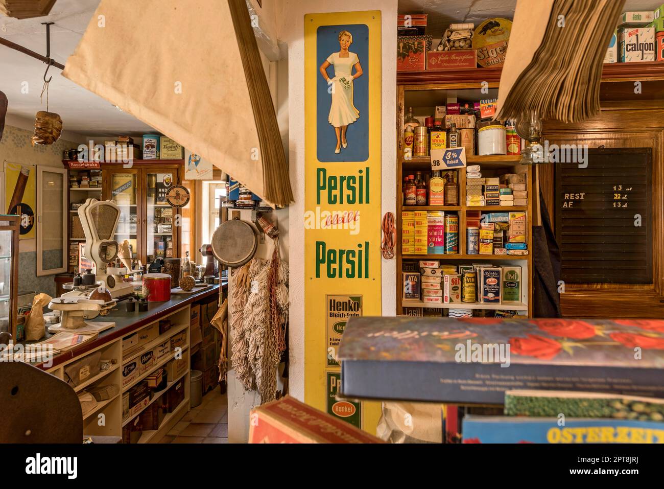 Counter, shelves with goods, tin sign with advertisement for Persil ...
