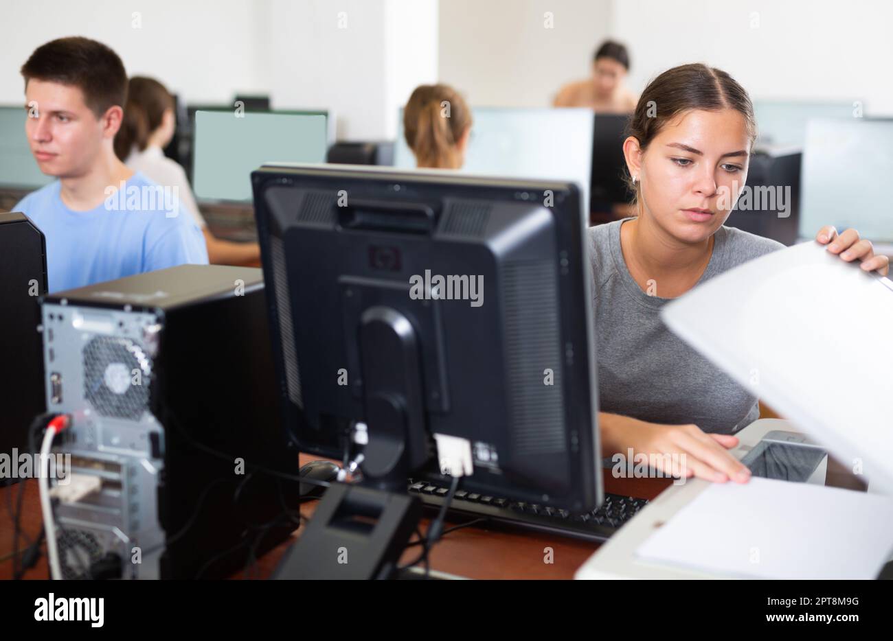 Young woman using scanner in computer class Stock Photo - Alamy