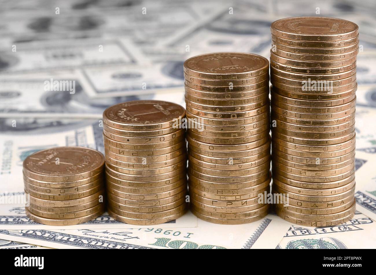 Stack of ukrainian coins in rising stacks grow up. Ukrainian money lies ...