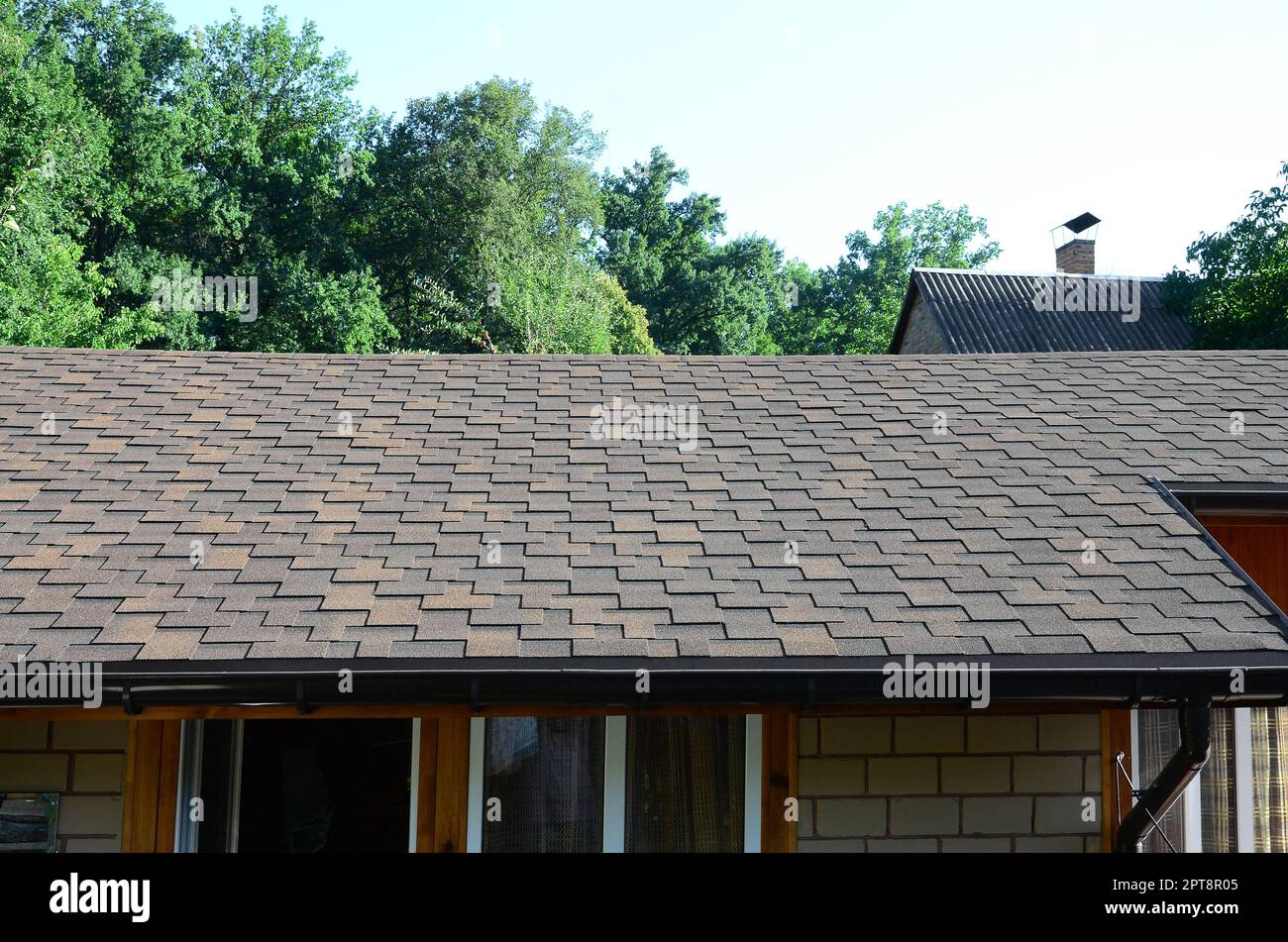 Modern roofing and decoration of chimneys. Flexible bitumen or slate ...