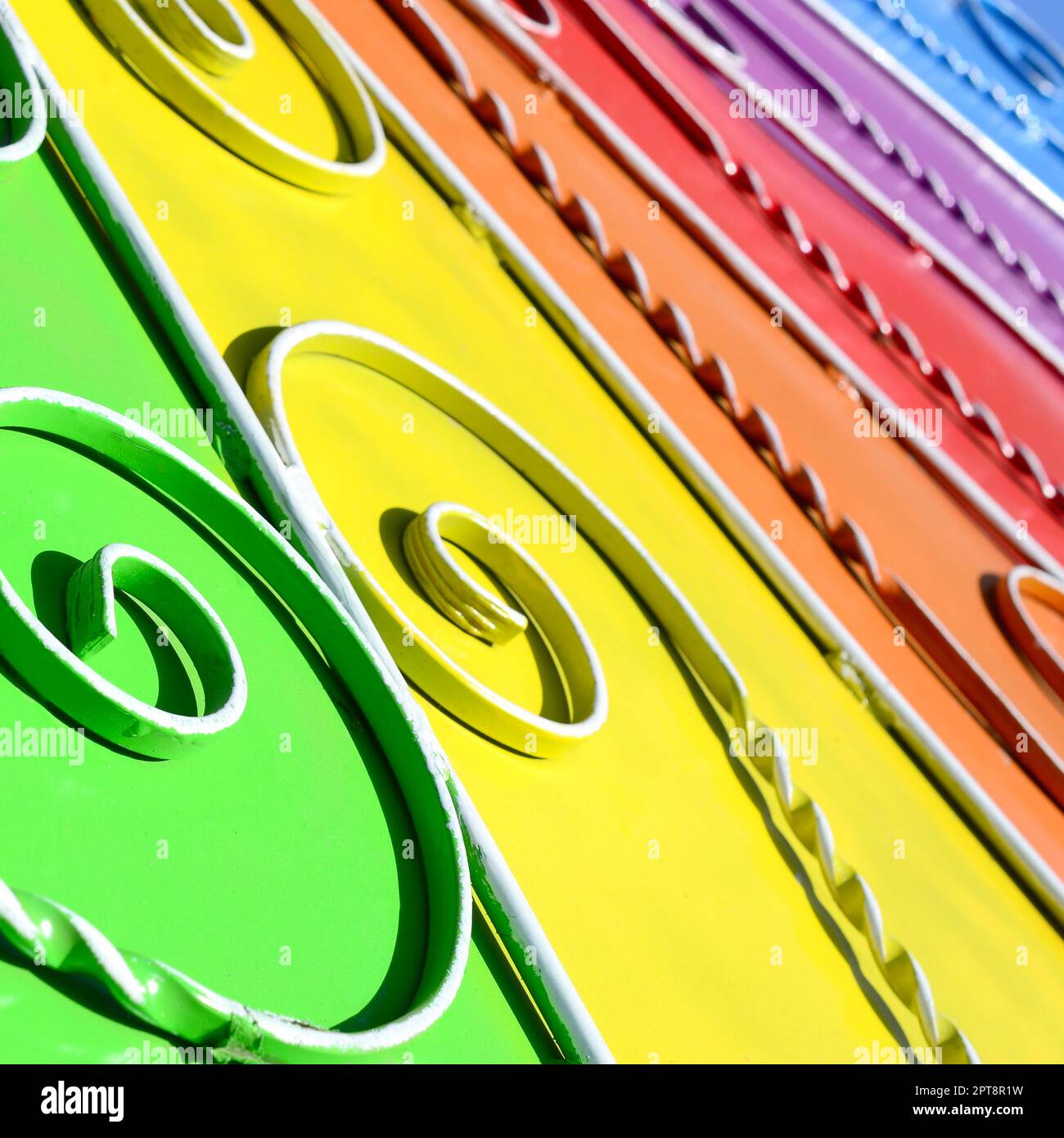 Metal texture of a piece of colored wall with a forged pattern. Rainbow ...
