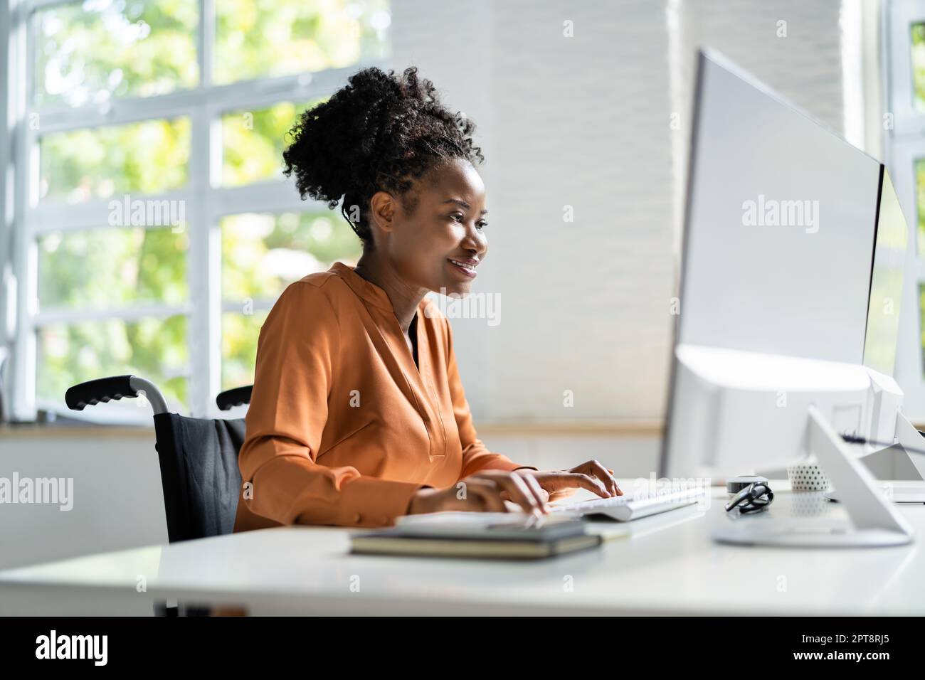 African American Black Woman Using Computer. Worker With Disability ...