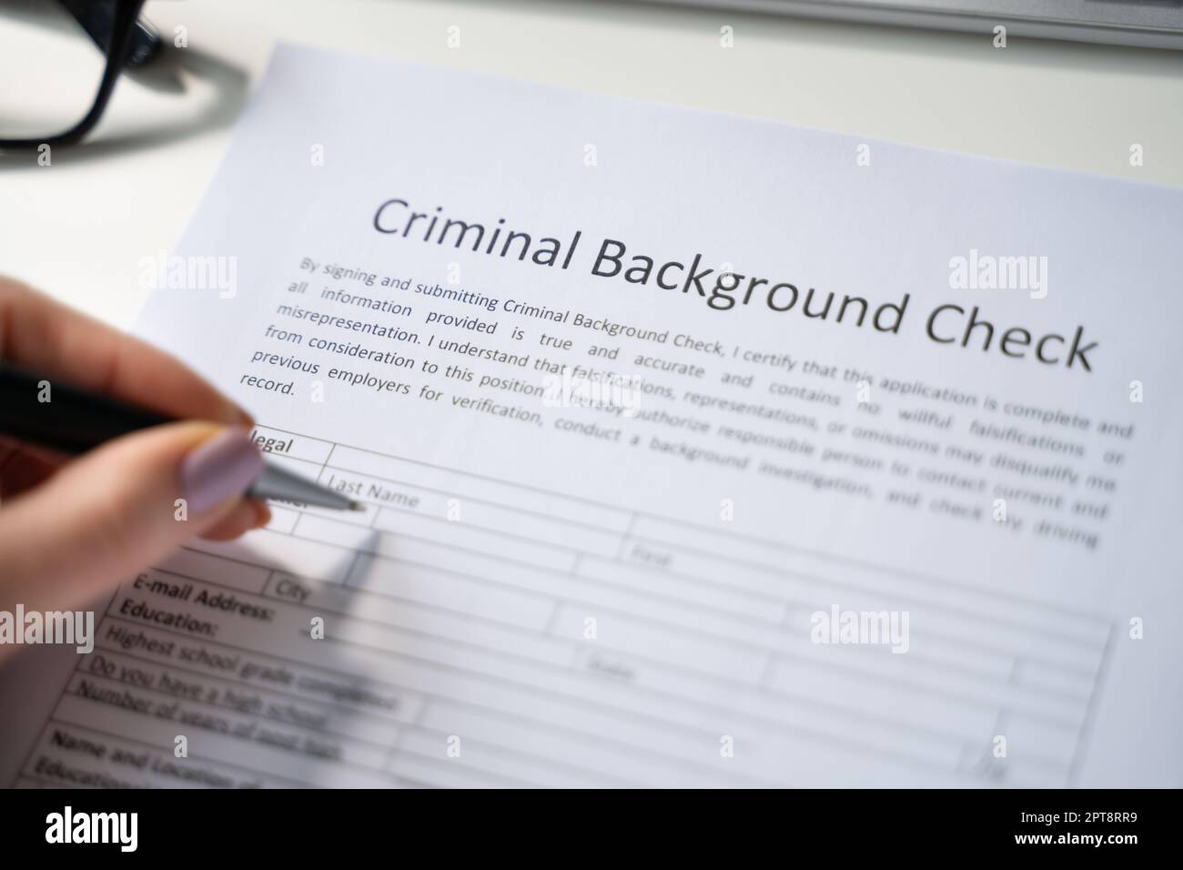 Close-up Of Human Hand Filling Criminal Background Check Application ...