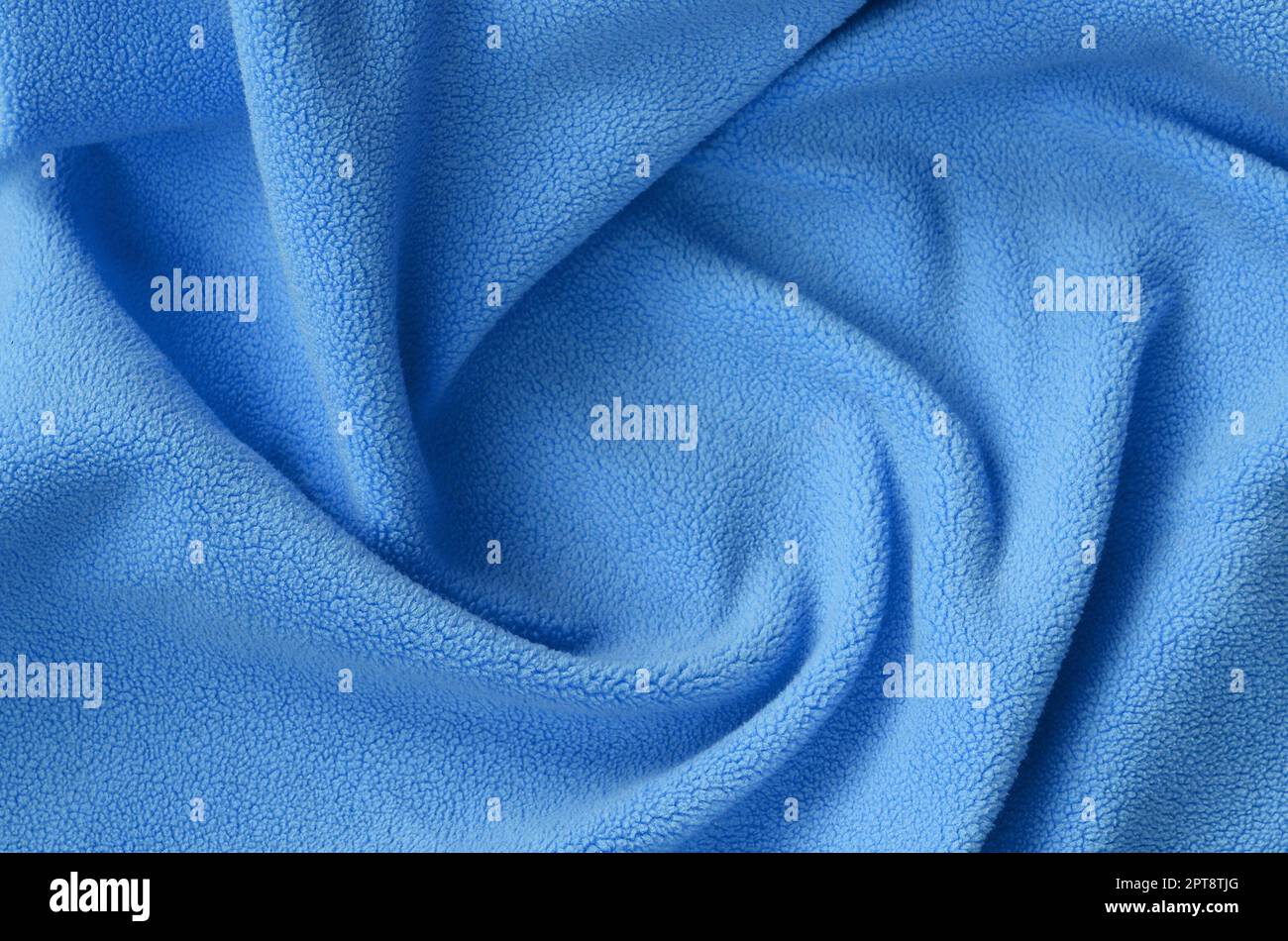 The blanket of furry blue fleece fabric. A background of light blue ...