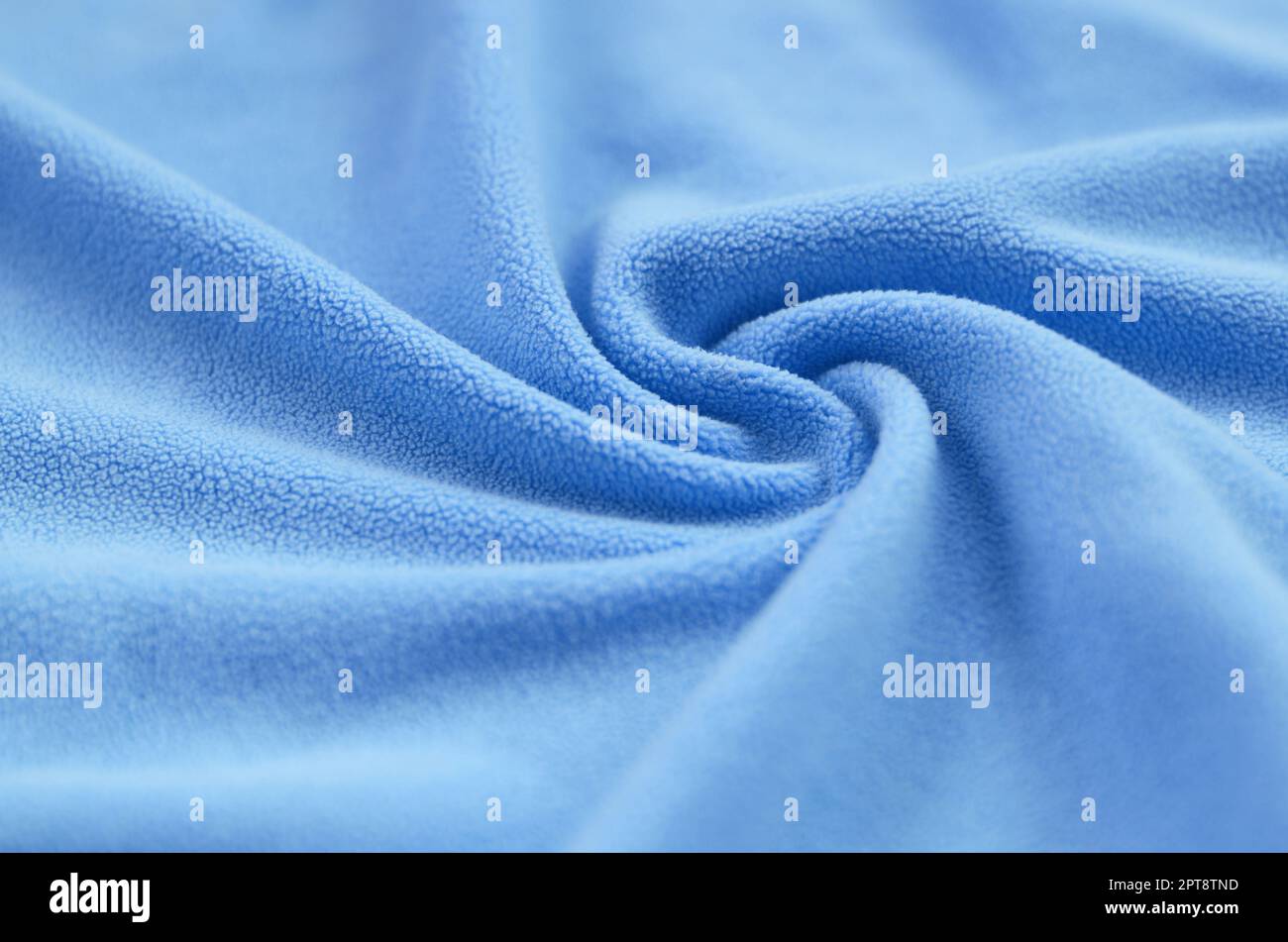 The blanket of furry blue fleece fabric. A background of light blue ...