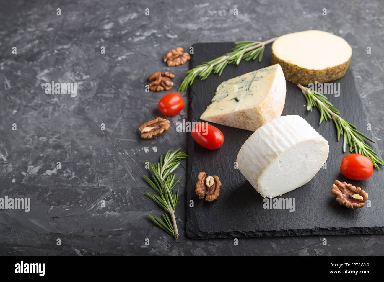 White goat cheese and various types of cheese with rosemary and ...