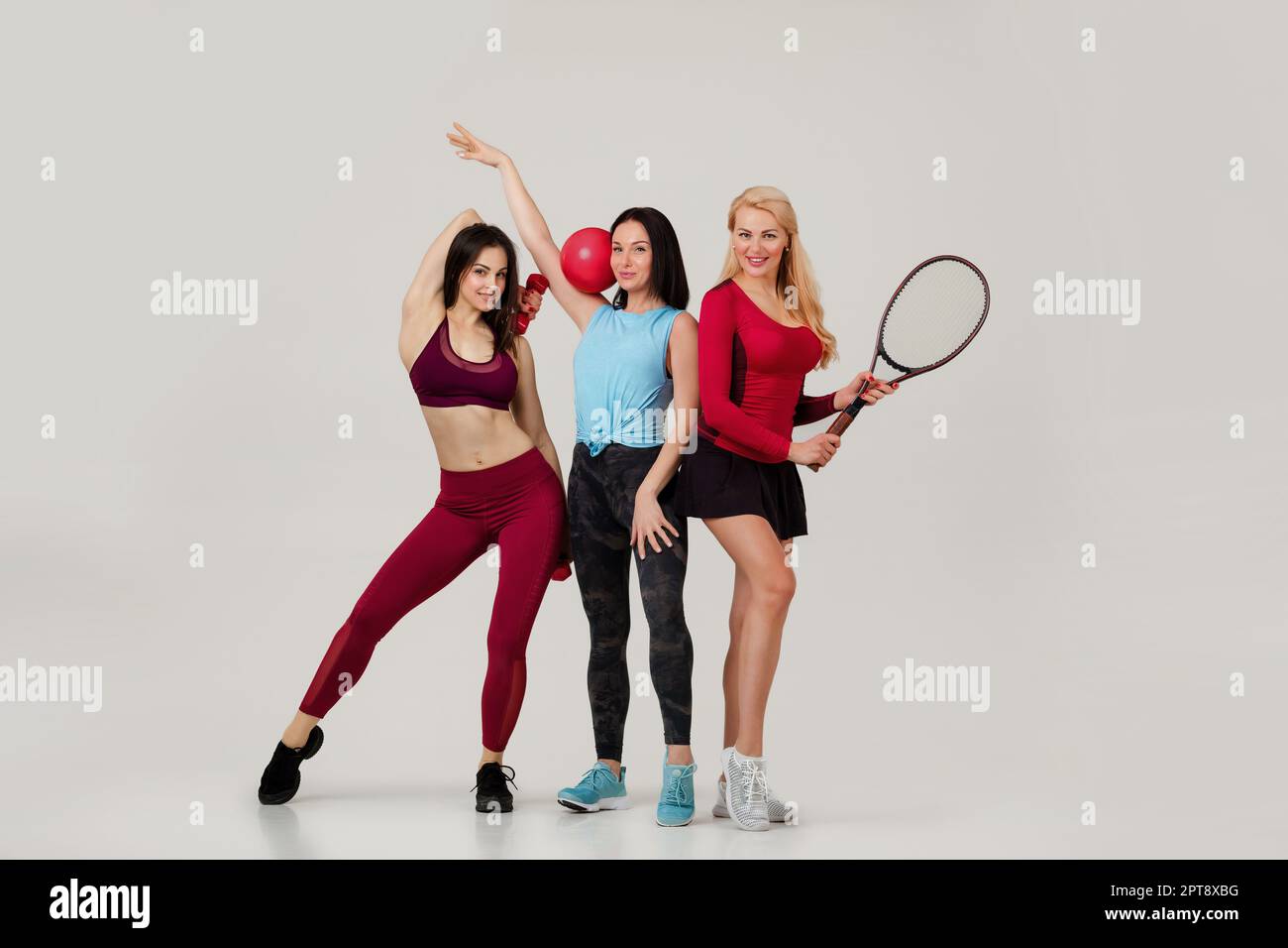 Group of fit attractive woman friends standing together with different ...