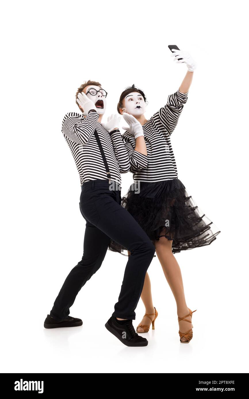 Smiling mimes in striped shirts. couple mimes making selfie on camera ...