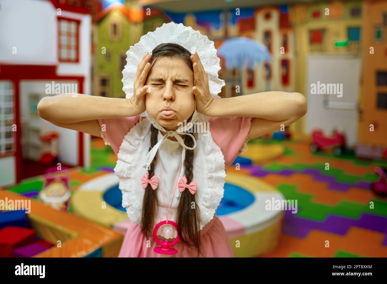 Portrait of funny woman wearing like newborn baby grimacing the face to ...