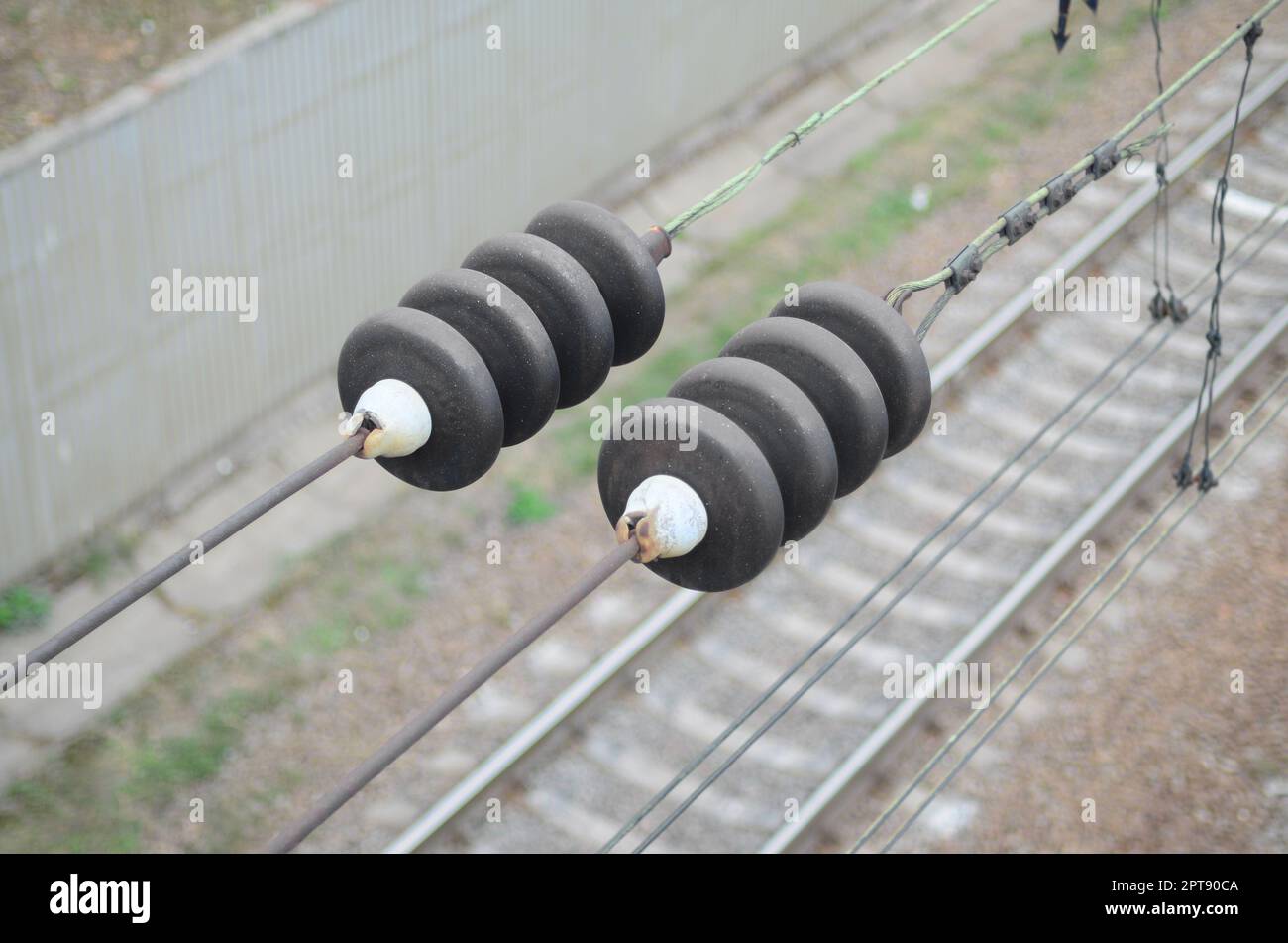 Electrical insulators on the contact wires on the background of a ...
