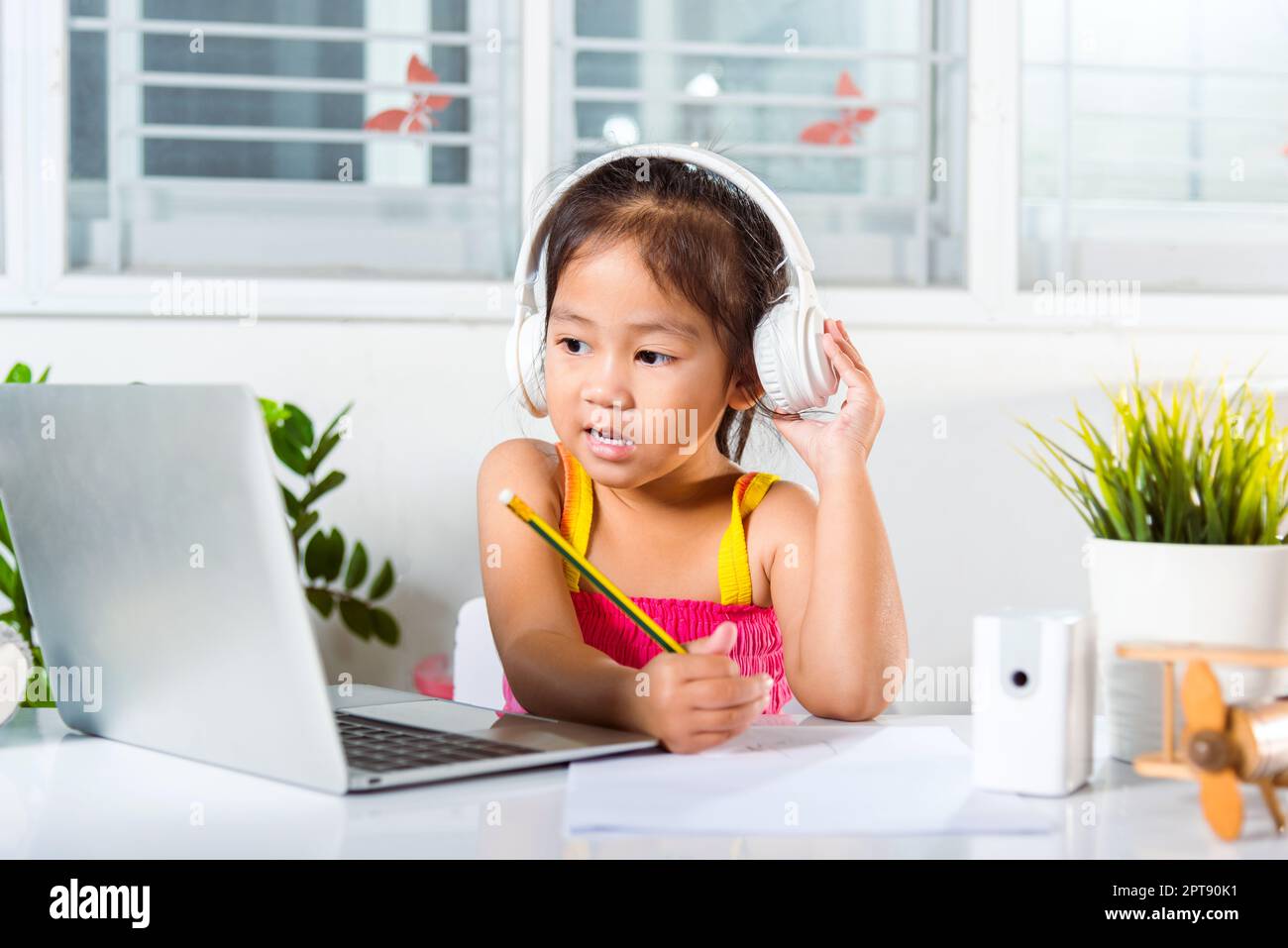 Asian child girl studying video conference distant education at home ...