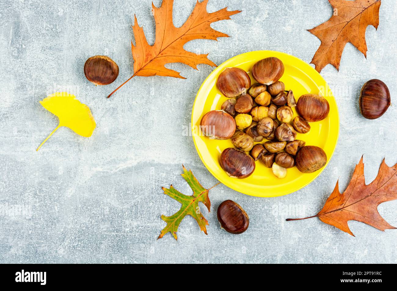 Roasted peeled chestnuts and autumn leaves. Delicious treat: roasted ...