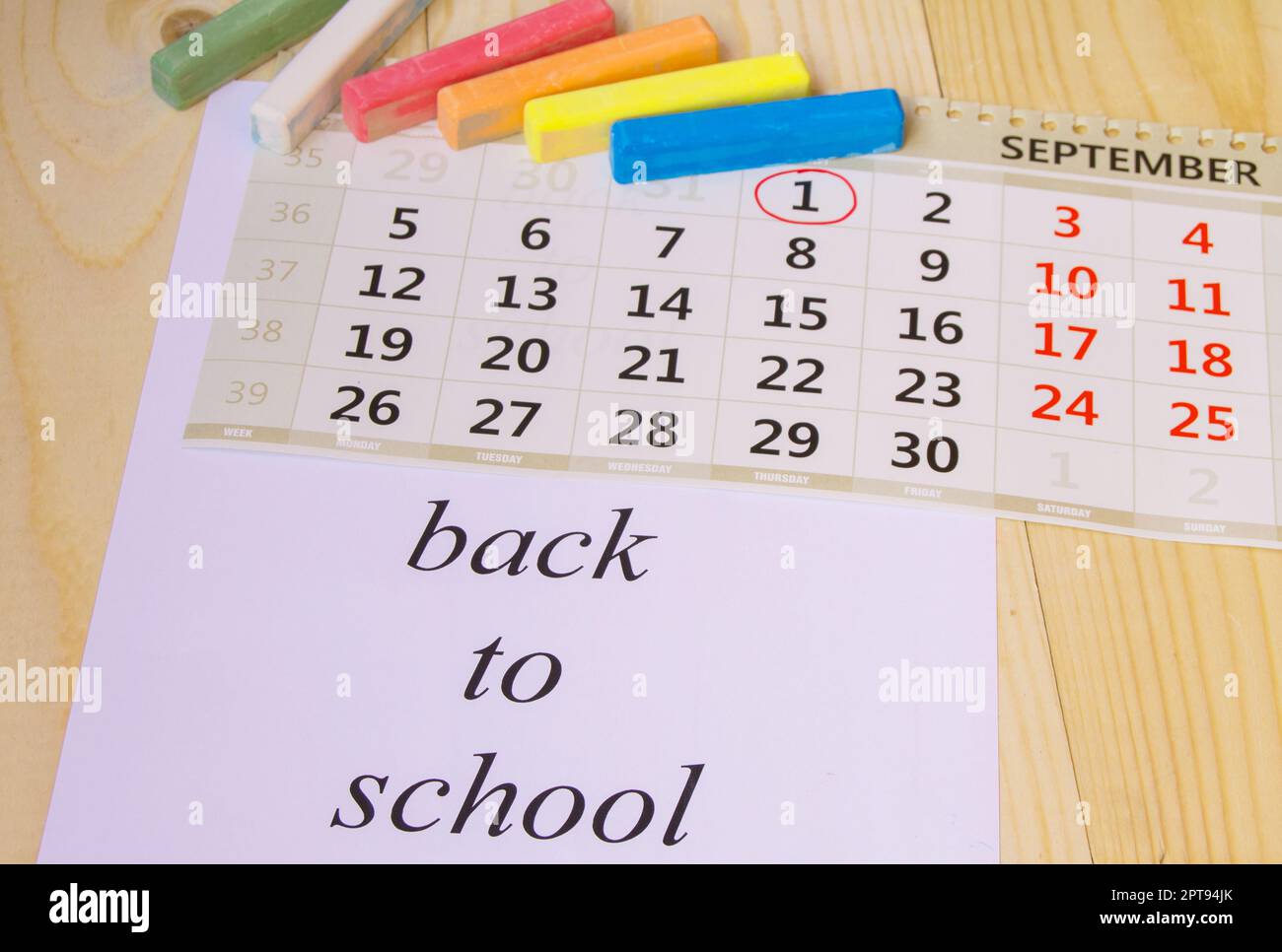 Back to school, calendar, colored chalk on wooden background Stock ...
