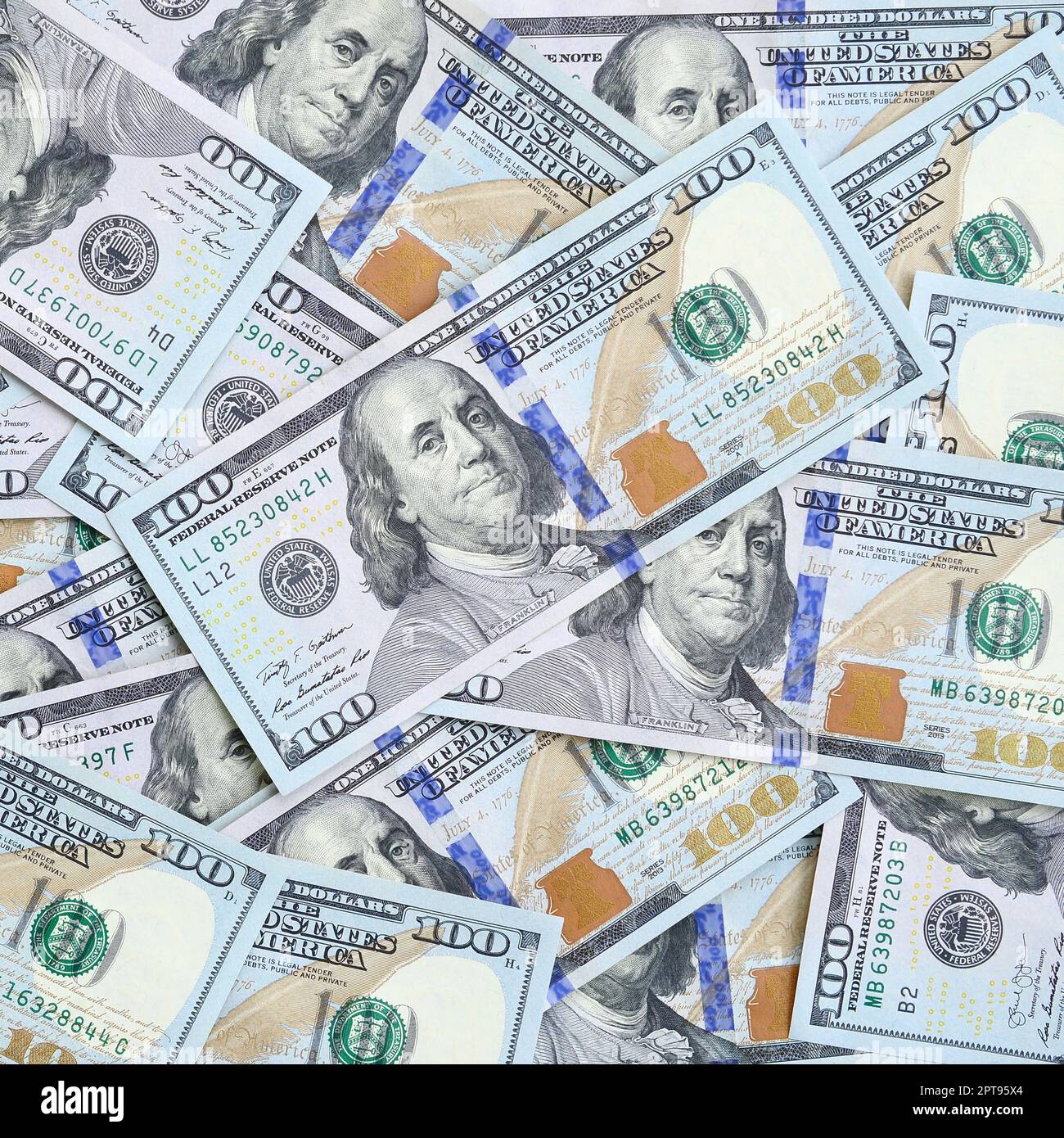 A large number of US dollar bills of a new design with a blue stripe in ...