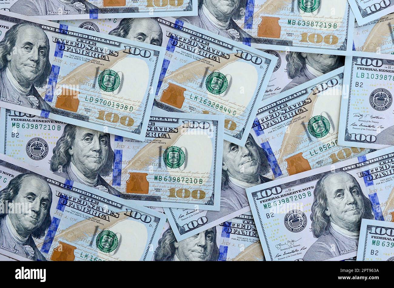 A large number of US dollar bills of a new design with a blue stripe in ...