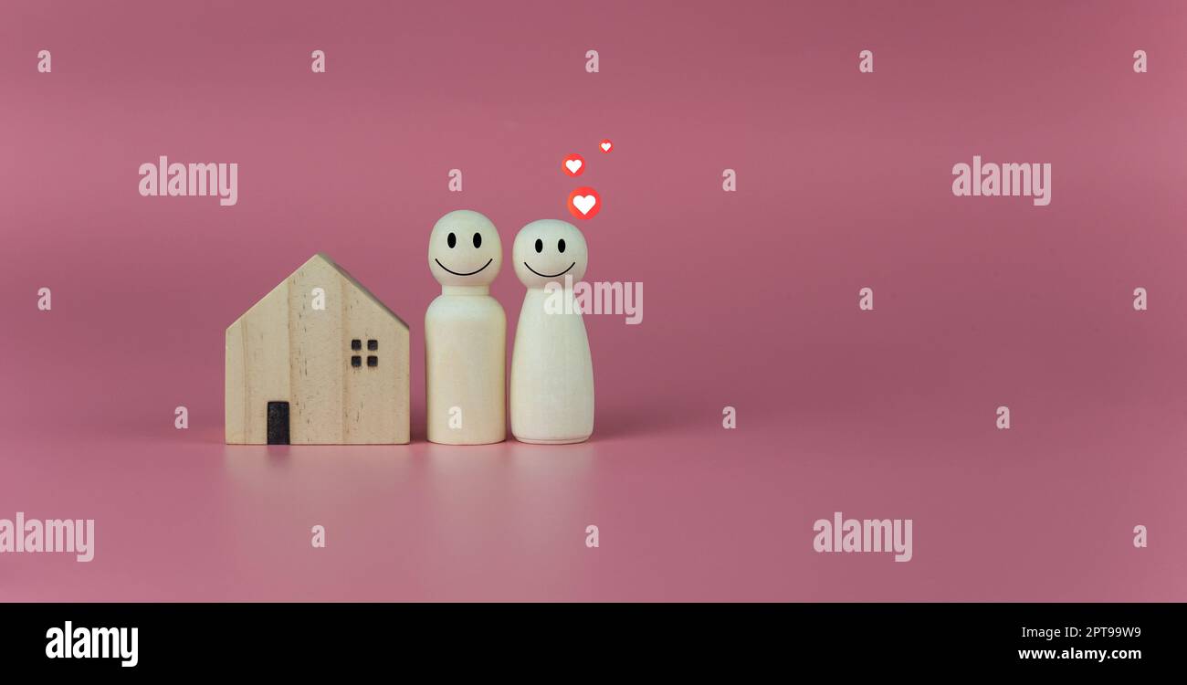 Happy house concept. Model house with wooden dolls standing lined up on ...
