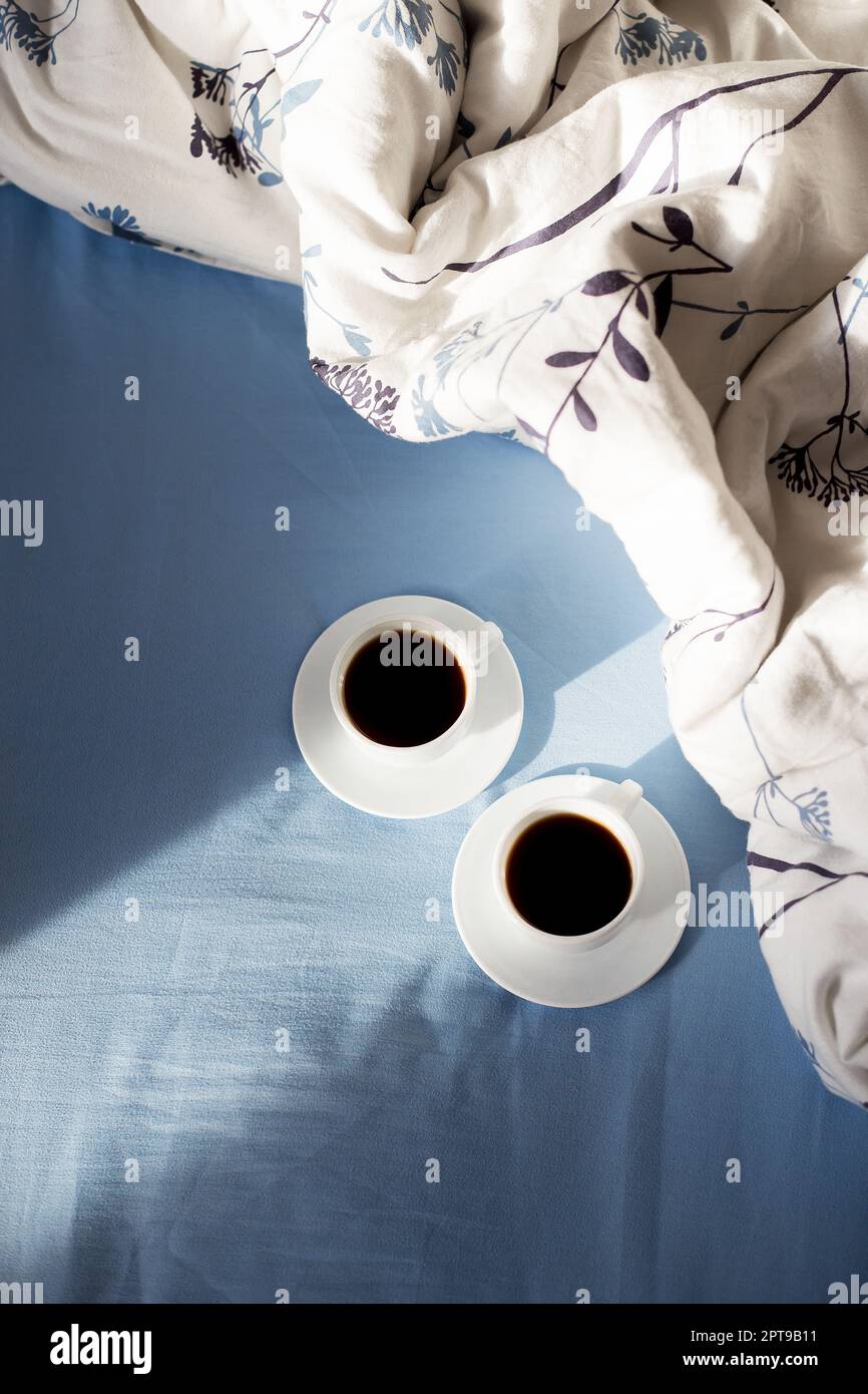 two cups of coffee in bed, sunlight Stock Photo - Alamy
