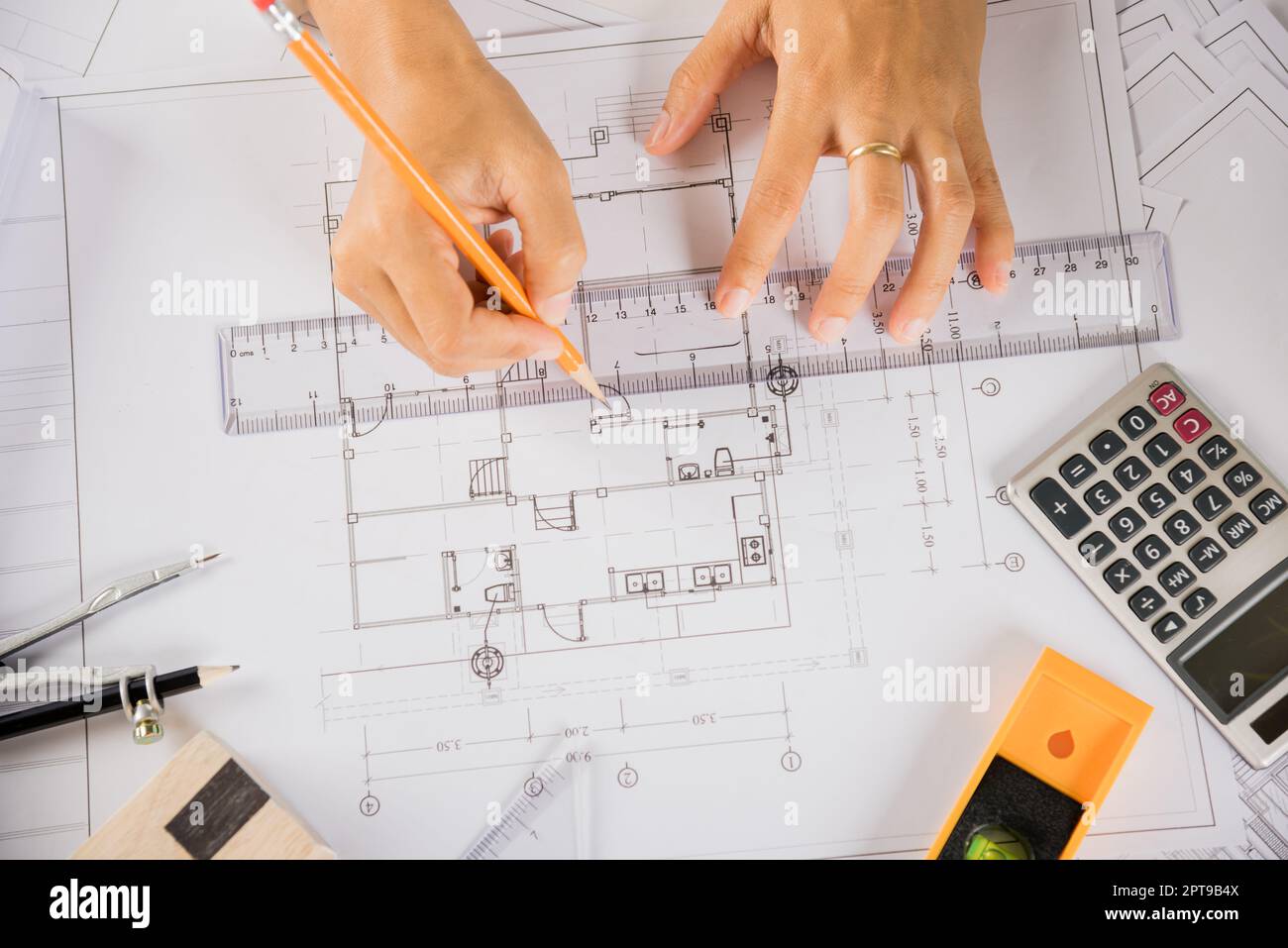 Architectural project workplace. Architect drawing with ruler on house ...