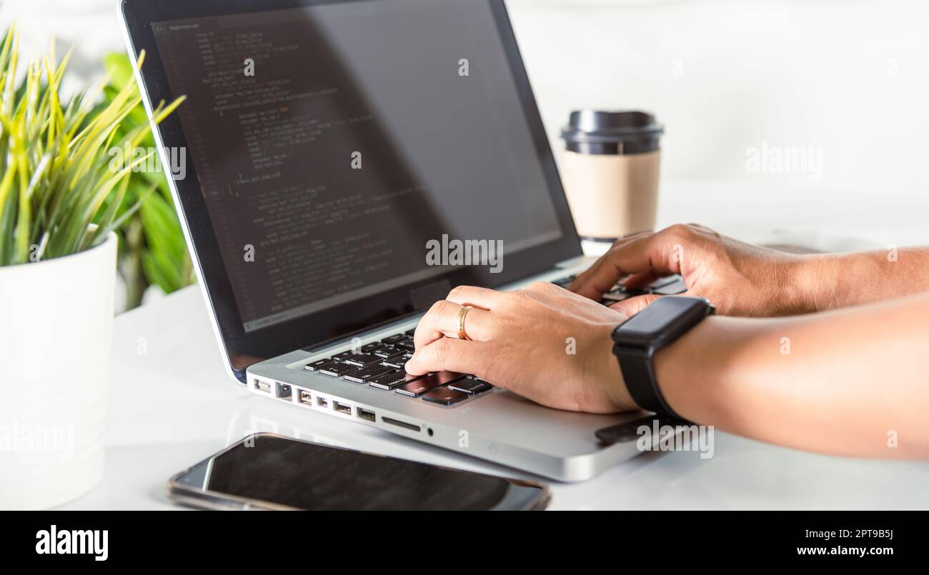 Programmer woman writing program HTML code sitting at workplace in ... Programmer woman writing program HTML code sitting at workplace in ...