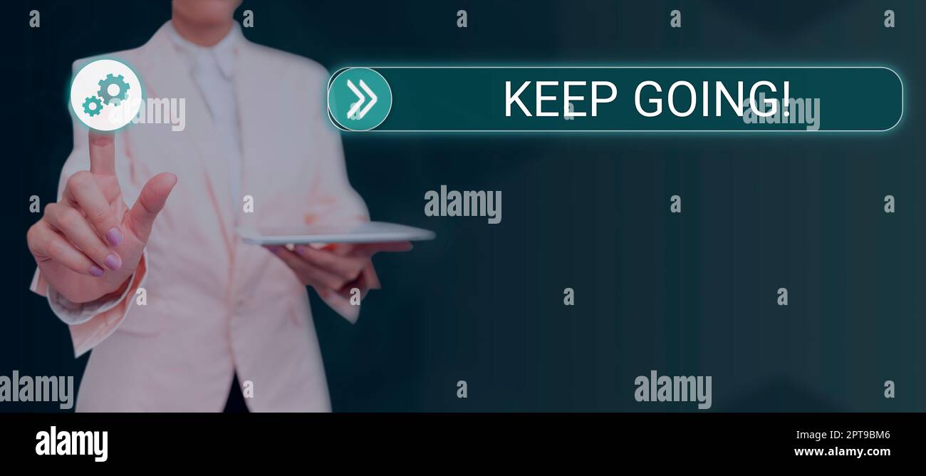 Sign displaying Keep Going, Word Written on to continue living normally ...
