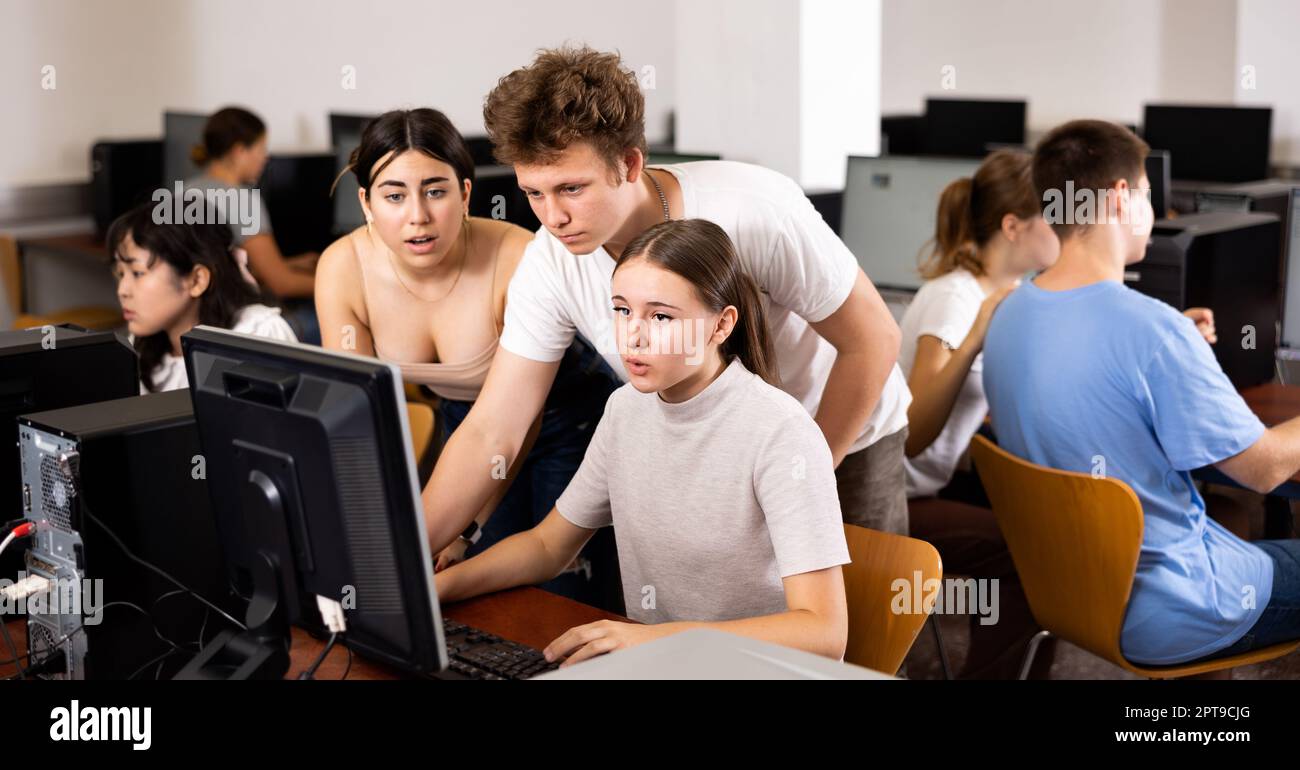 Boy helping friend computer hi-res stock photography and images - Alamy