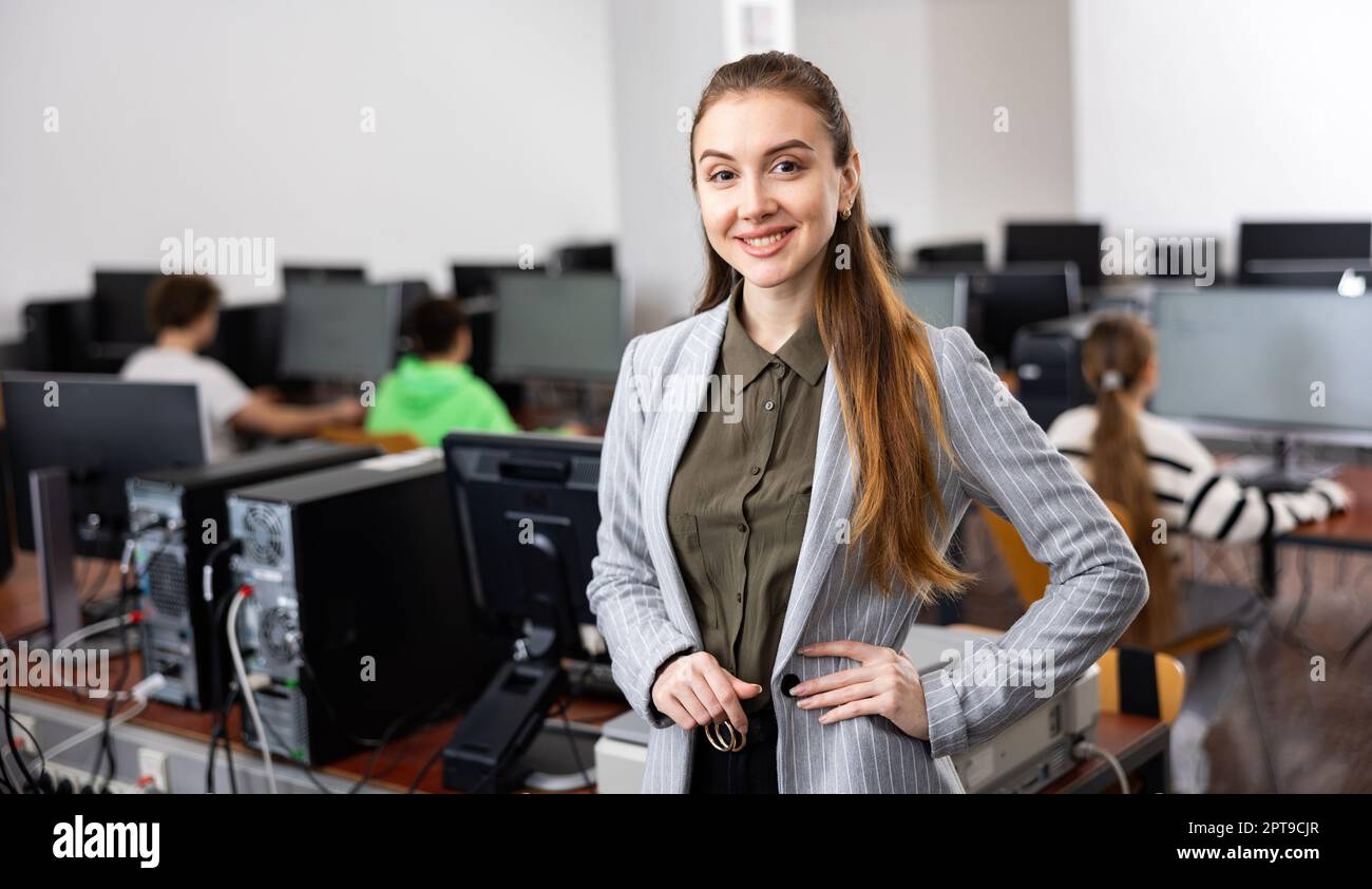 Portrait of young smiling female computer class teacher at school Stock ...