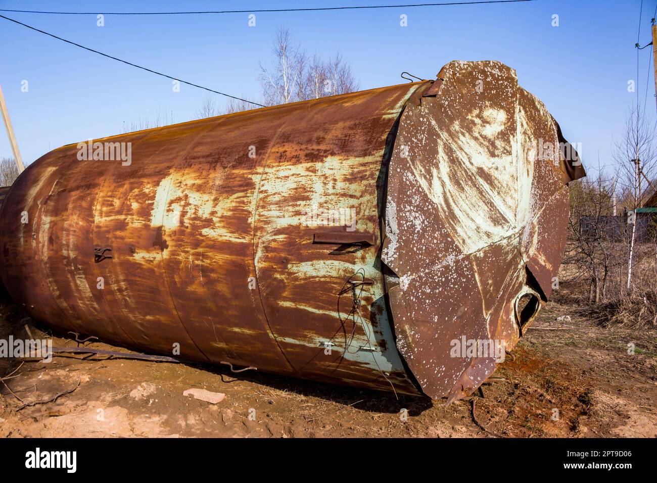 Old rusty water tower lying on the ground Stock Photo - Alamy