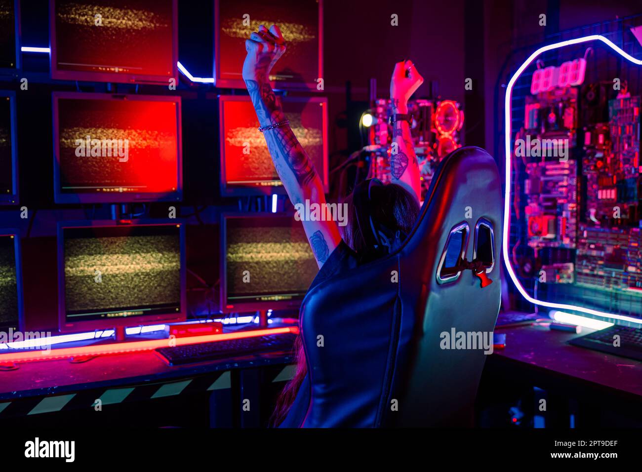 Winner. Happy young gamer plays online video games computer she raises ...