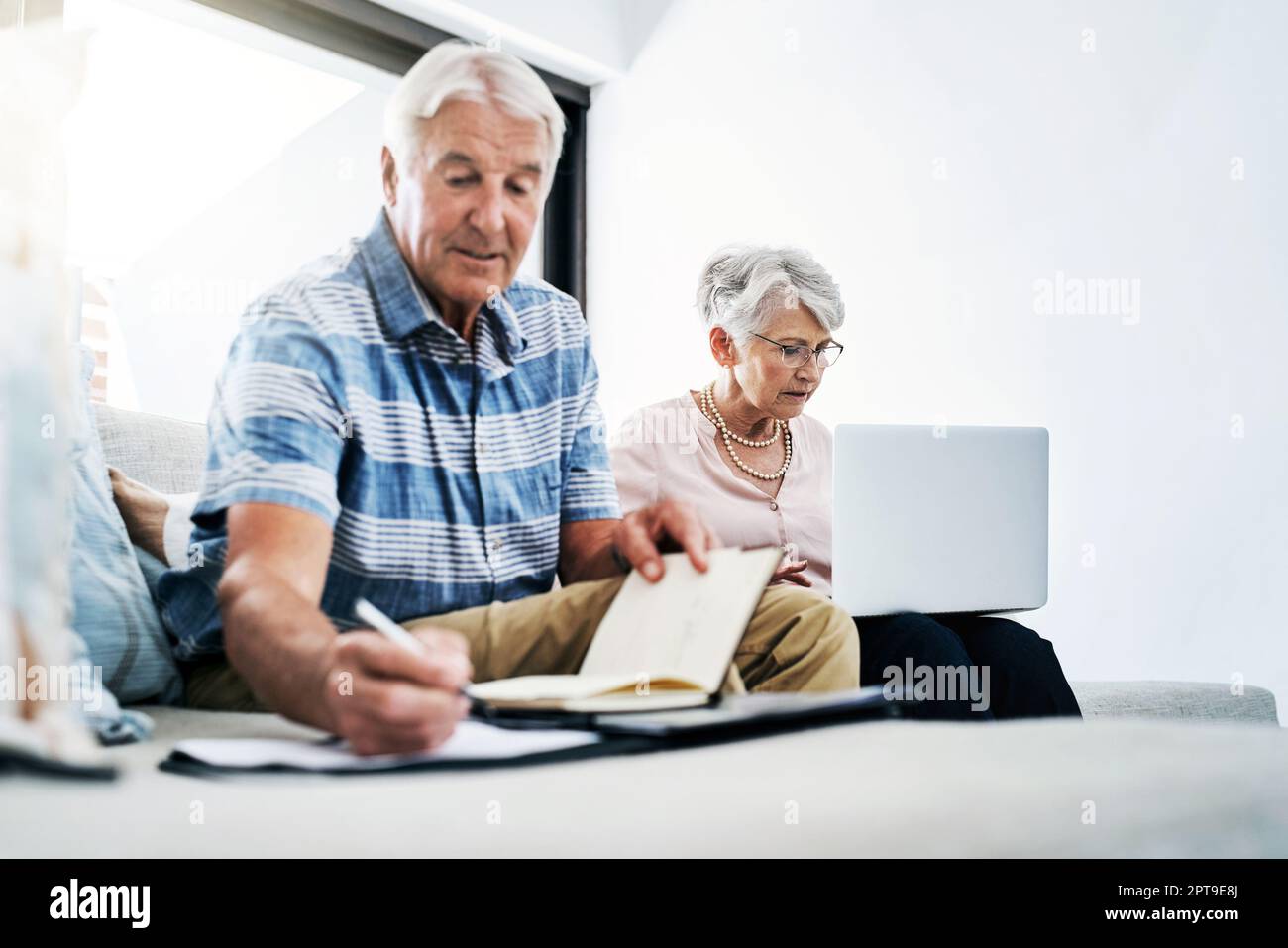 Keeping track of their income and expenditure. a senior couple going ...