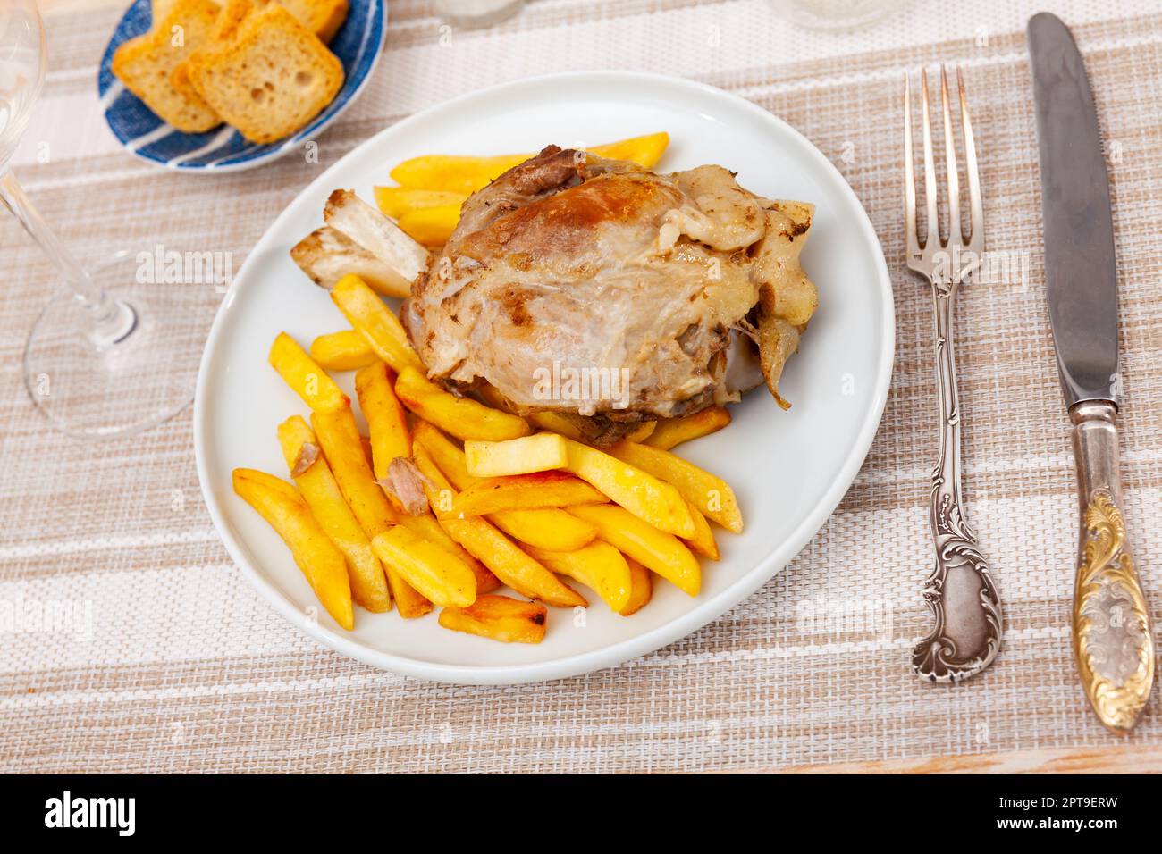Roasted pork knuckle with vegetable garnish of fried potatoes Stock ...