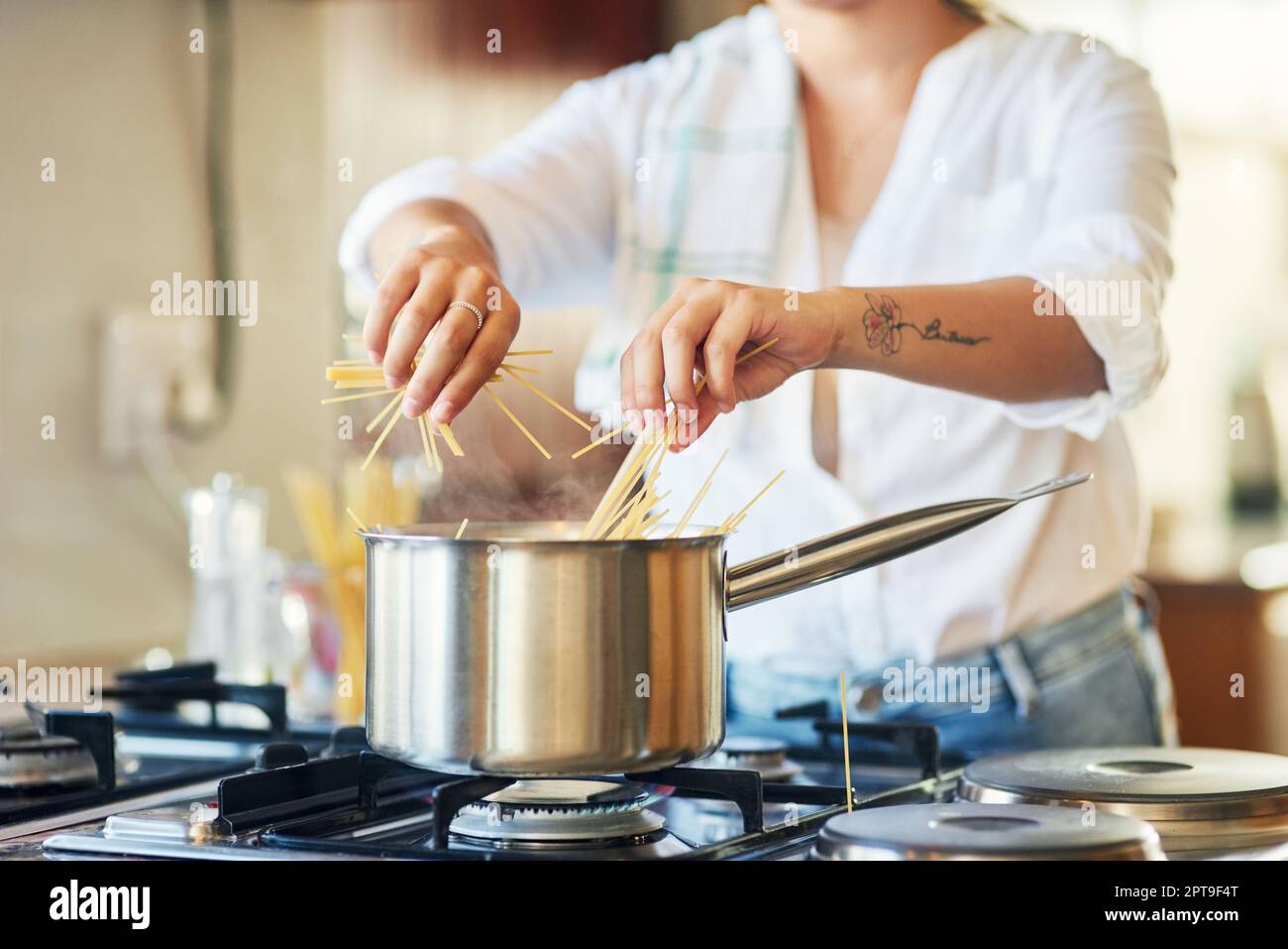 Ill show you how to cook the perfect pasta. a woman breaking spaghetti ...