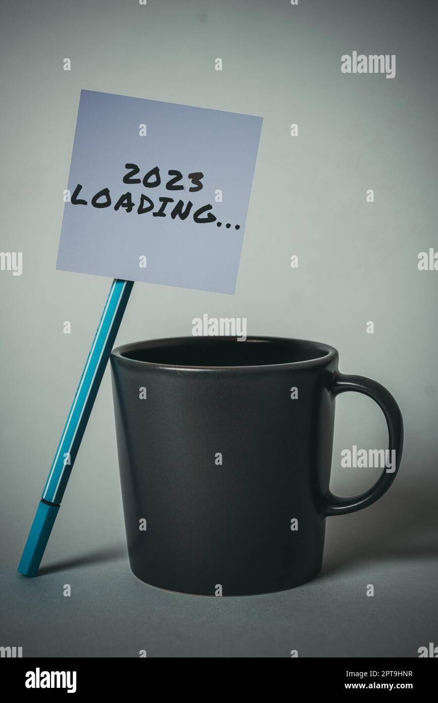 Hand writing sign 2023 Loading..., Business idea a year composed of a series of events that are ...