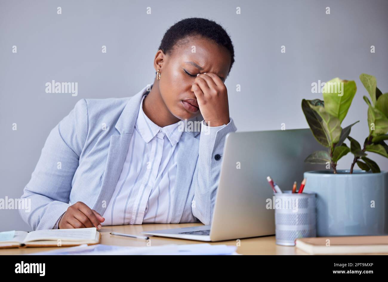 This is so difficult. a businesswoman experiencing a headache at work ...