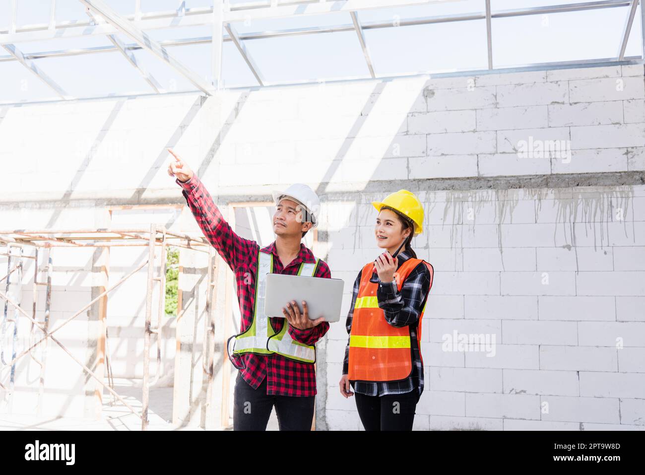 Asian engineer foreman worker man and woman working at building ...