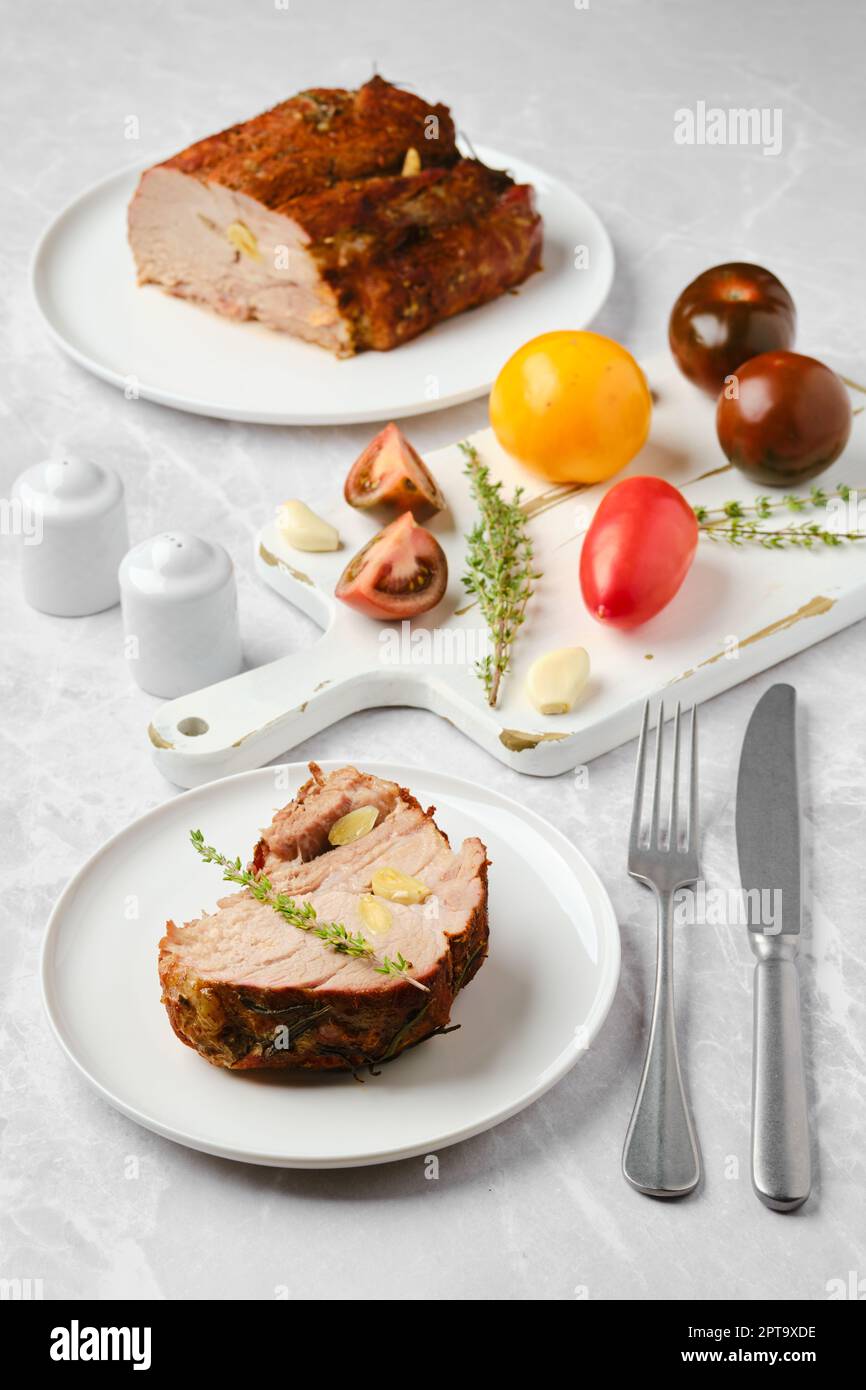 Pork neck baked in oven with garlic and herbs Stock Photo - Alamy