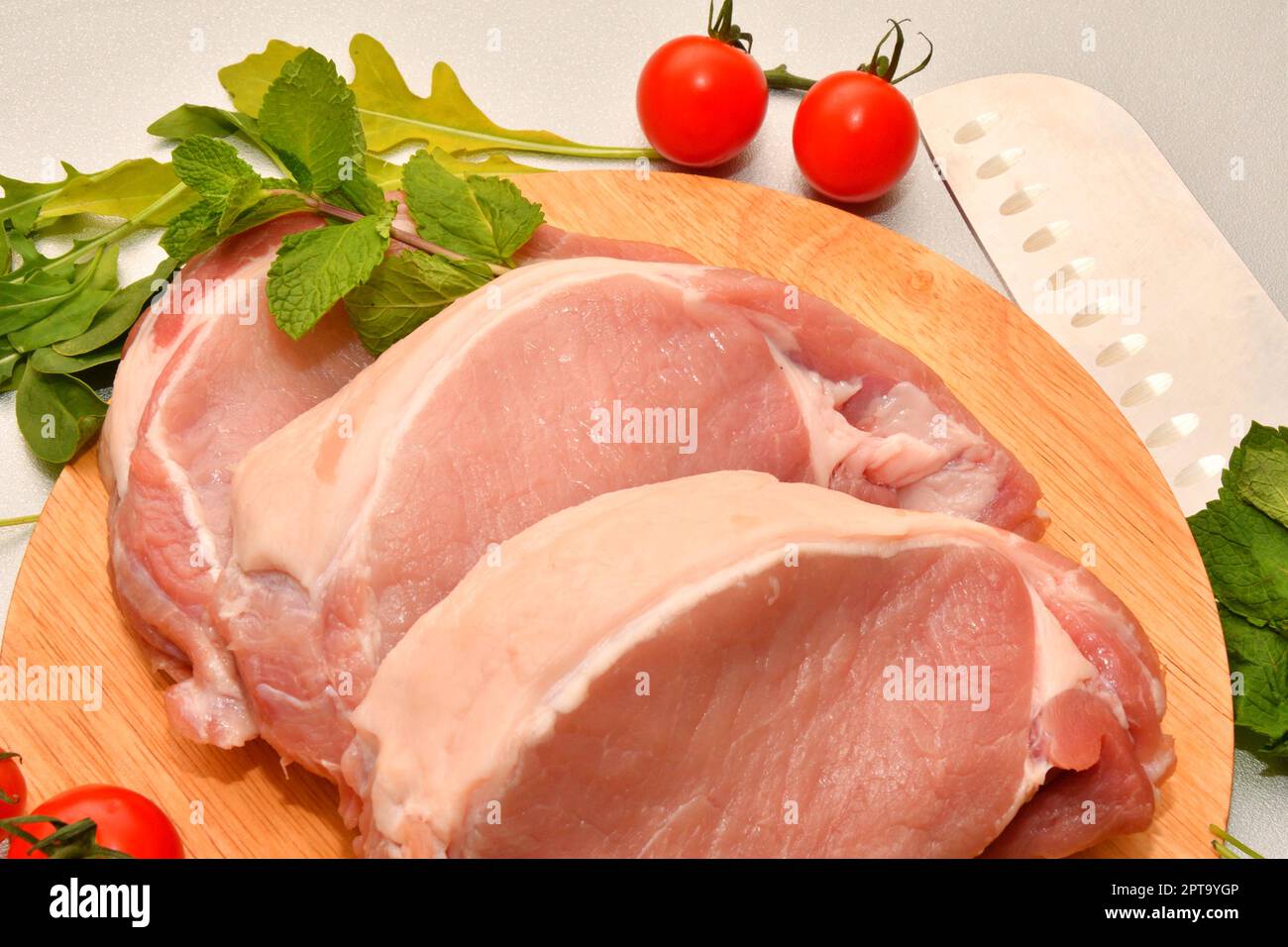 Layers of meat sliced from pork tenderloin for cooking escalope Stock ...