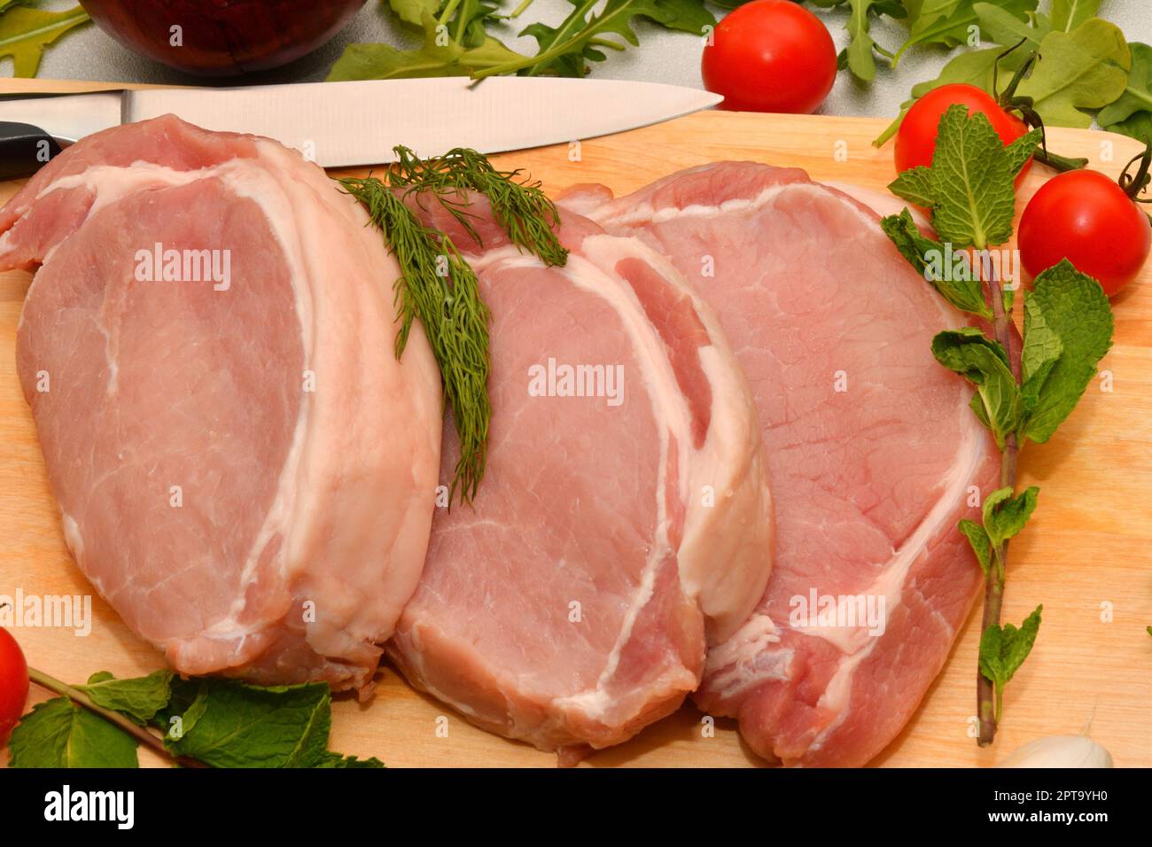 Layers of meat sliced from pork tenderloin for cooking escalope Stock ...