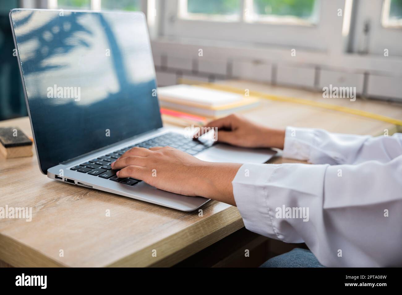 Back to school. Close up hands of female using computer sitting at ...