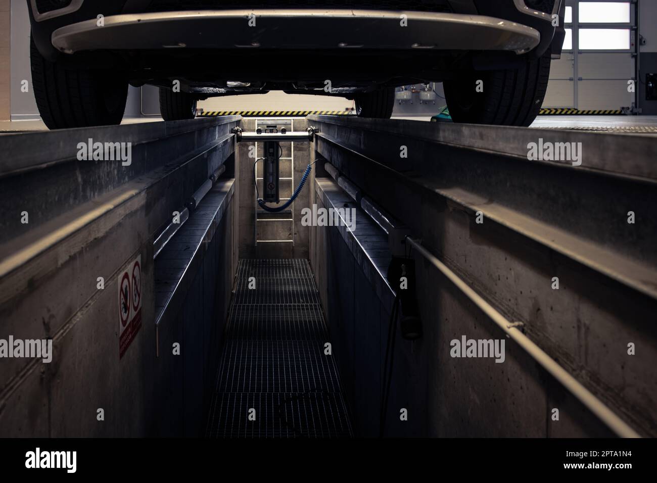 Car in a garage undergoing regular checks (shallow DOF/color toned ...