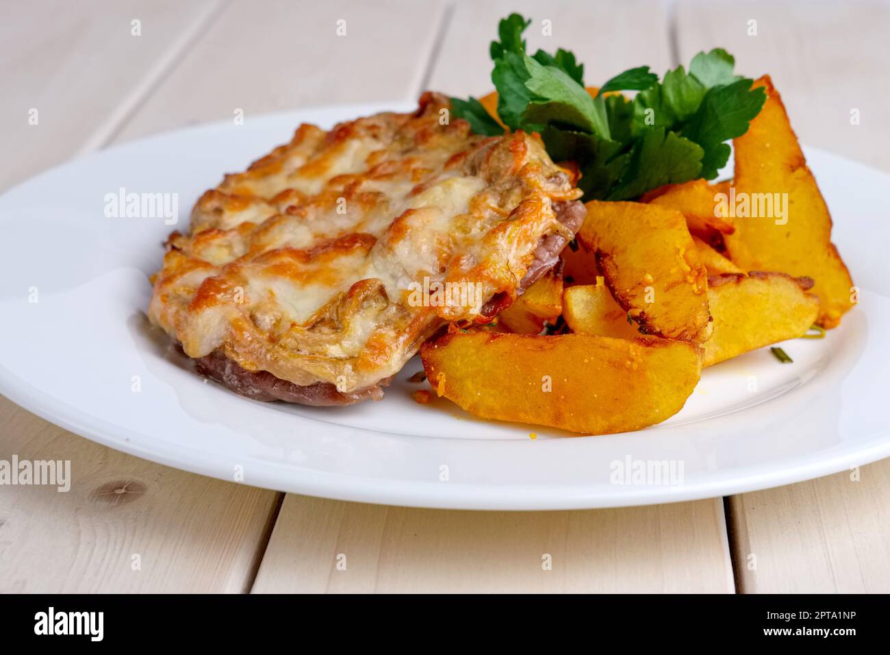 Close up view of plate with fried chopped meat and country style potato ...