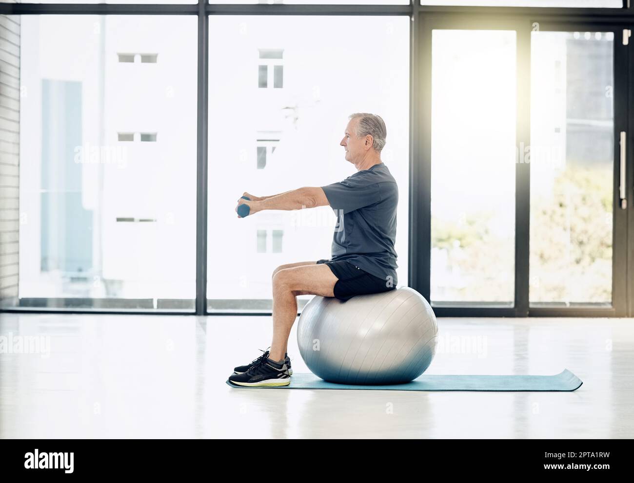 Posture is important at every age. an elderly man working out with ...