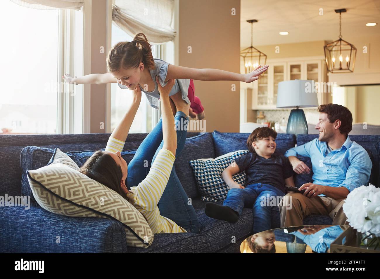 Enjoying some family fun. a happy family bonding together at home Stock ...