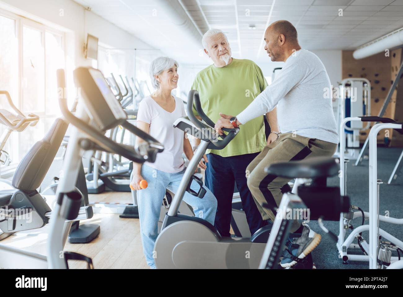 Three positive senior people exercising in Gym Stock Photo - Alamy