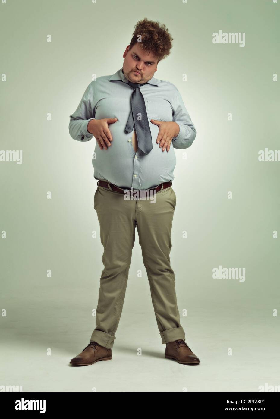 Want some of this. Full length shot of an overweight man holding his ...