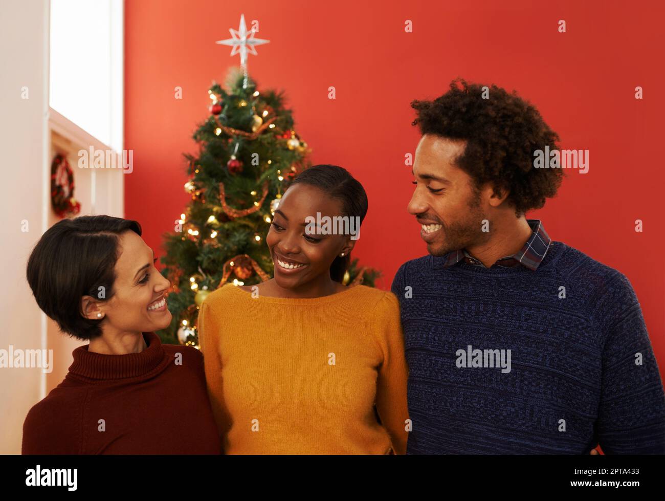 Time to open the presents. a group of young people celebrating ...