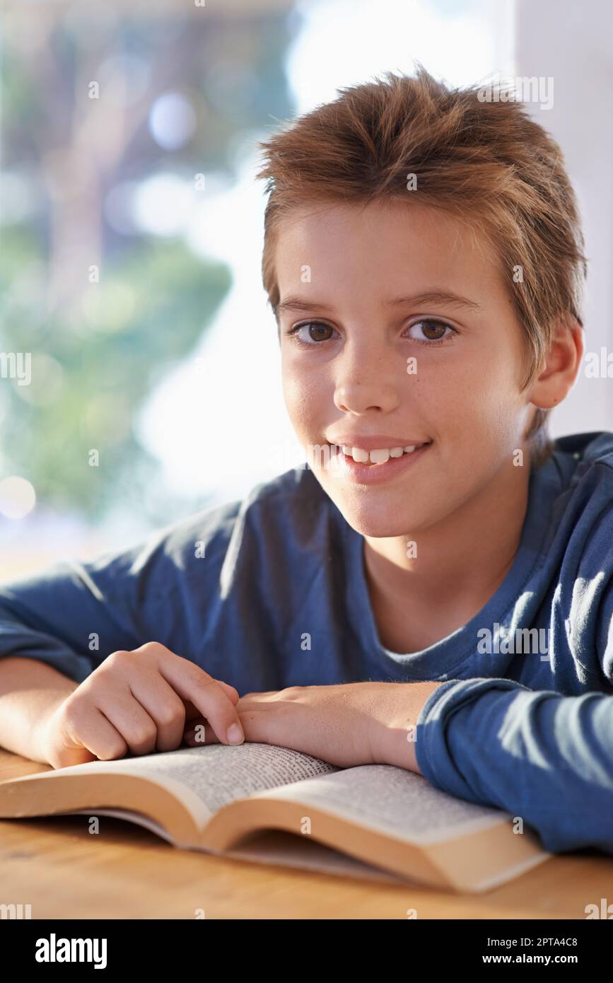 He loves escaping into the worlds of his books. Portrait of a young boy ...