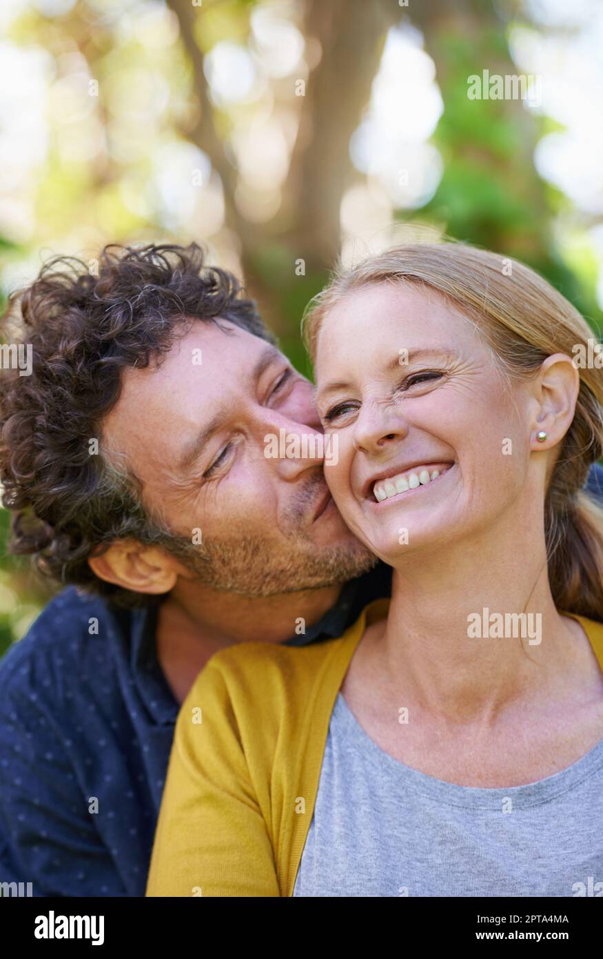 Giving Her A Big Kiss On The Cheek An Affectionate Husband And Wife