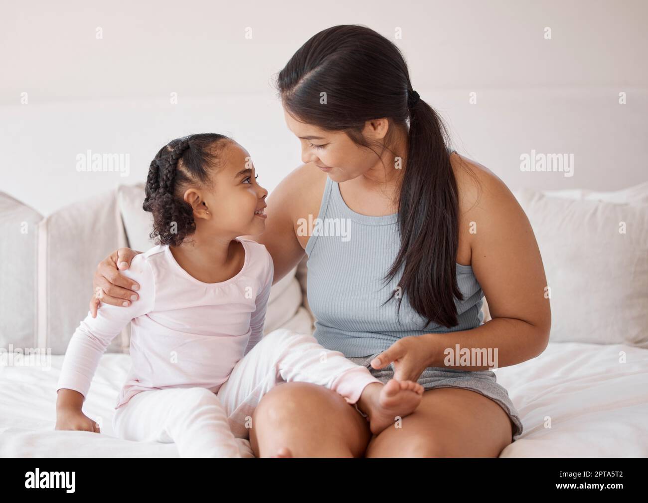 Mother with girl child talk on bed, smile and love together in home ...